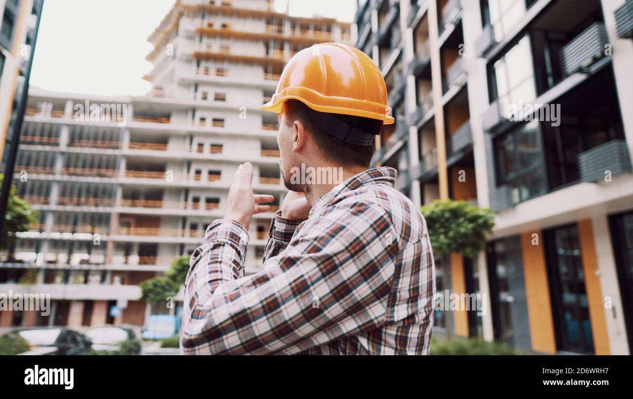 Engineer talking on phone. Architect using phone on construction site ...