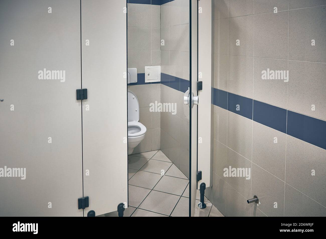 Open door of public toilet stall. Toilet bowl inside toilet stall Stock ...