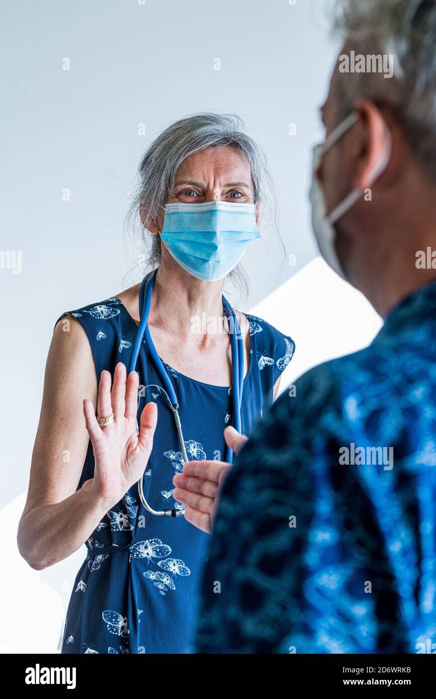 Doctor refusing to shake hands with a patient Stock Photo - Alamy