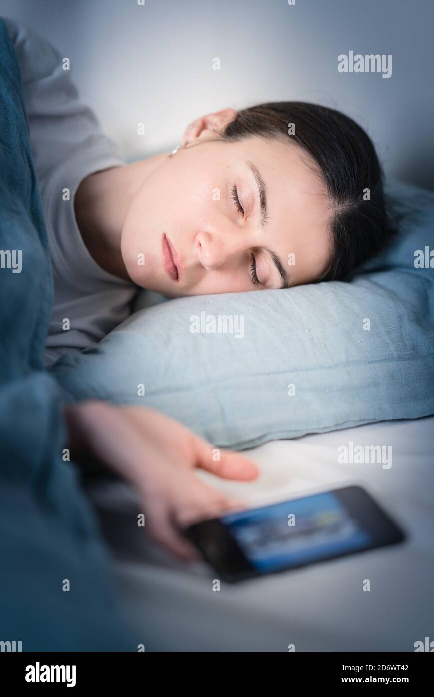 Sleeping woman with a cell phone Stock Photo - Alamy