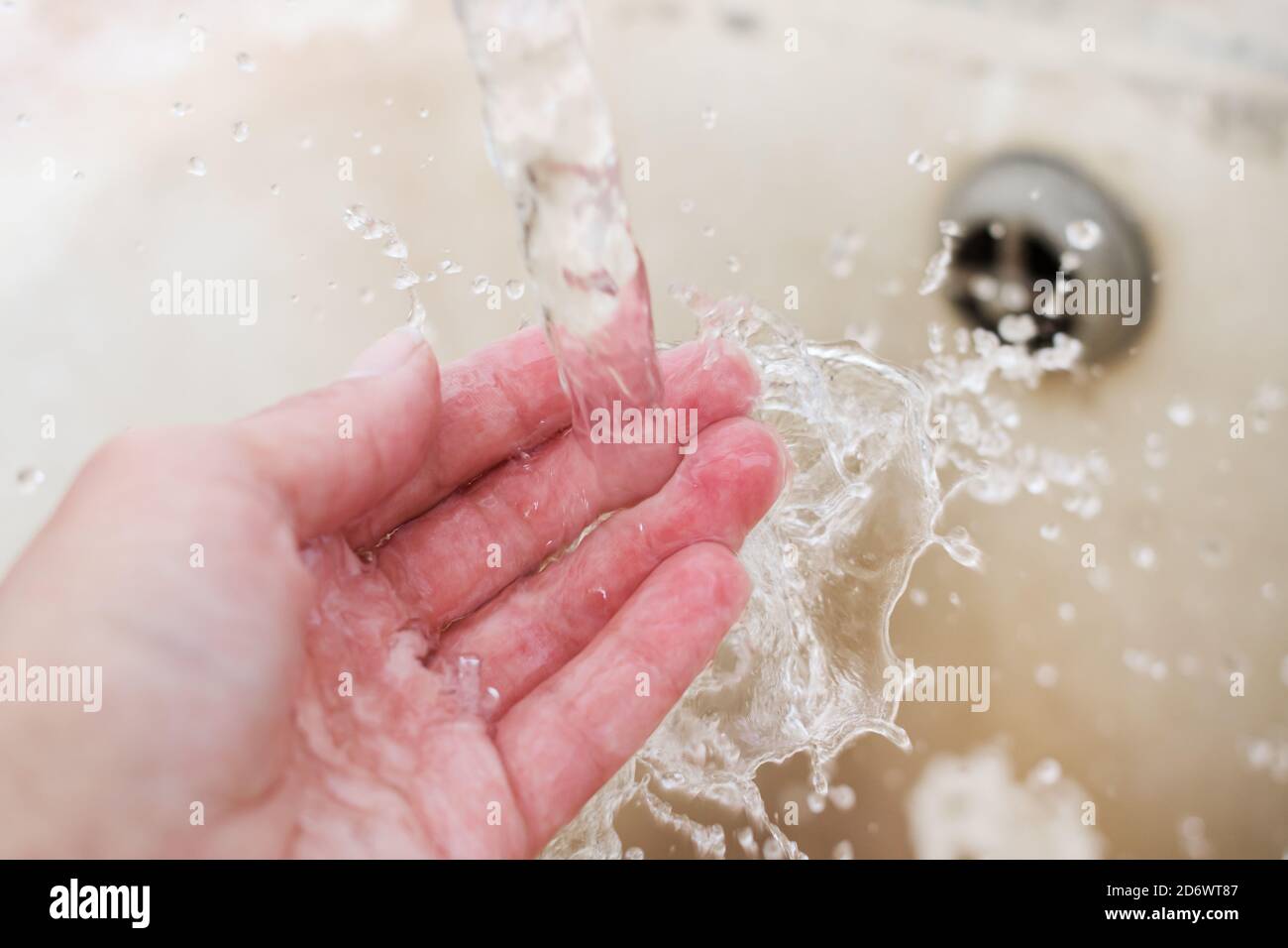 Hand under the tap in the bathroom Stock Photo - Alamy