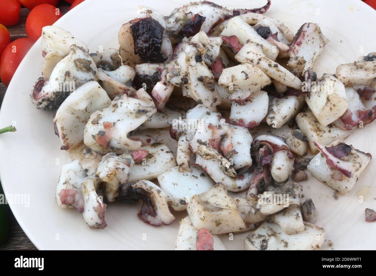 cooked octopus tentacles as sea food with tomatoes and peppers ...