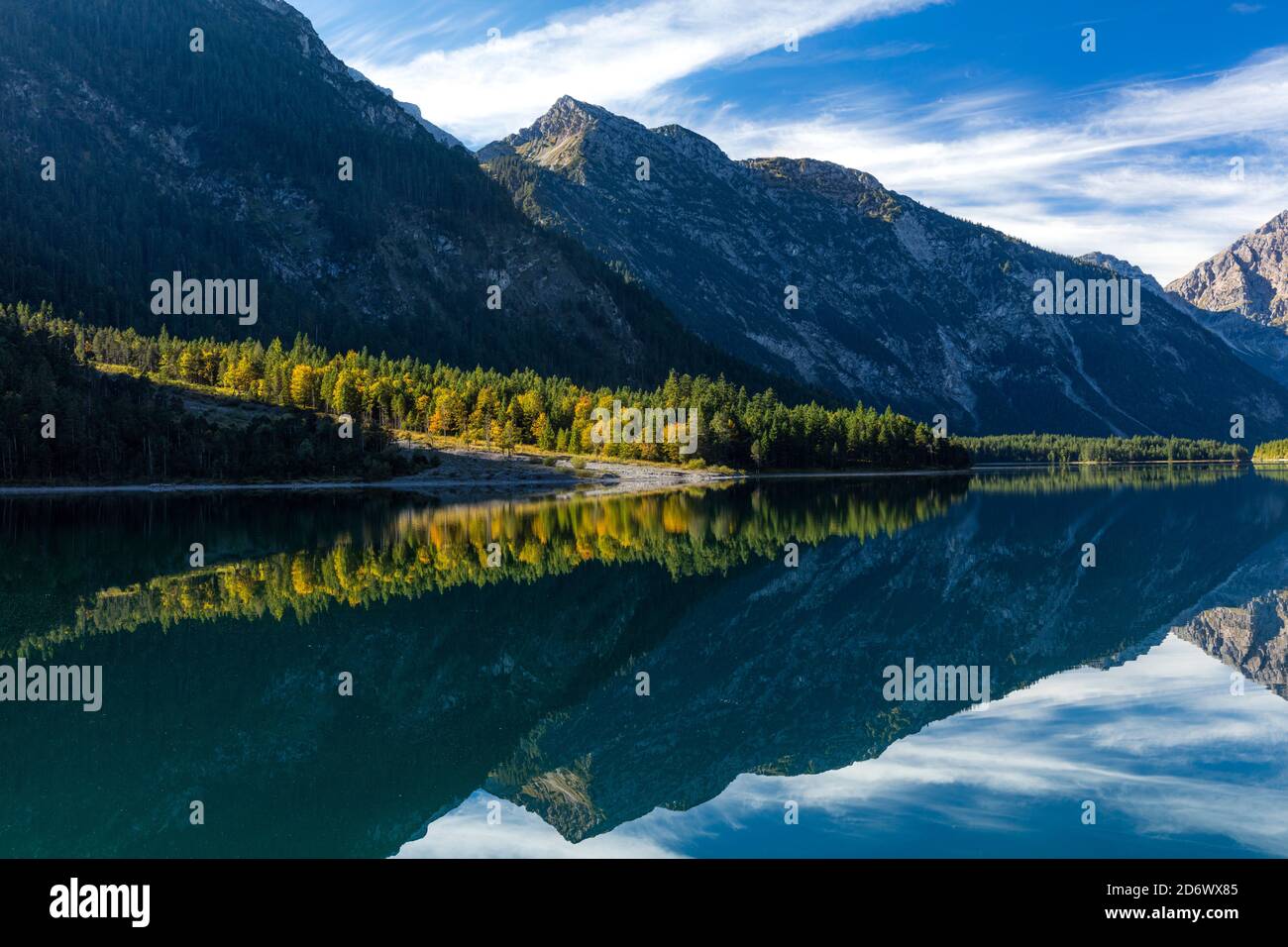 Fall color in the Tyrolean Alps reflected in Plansee, Tyrol, Austria ...