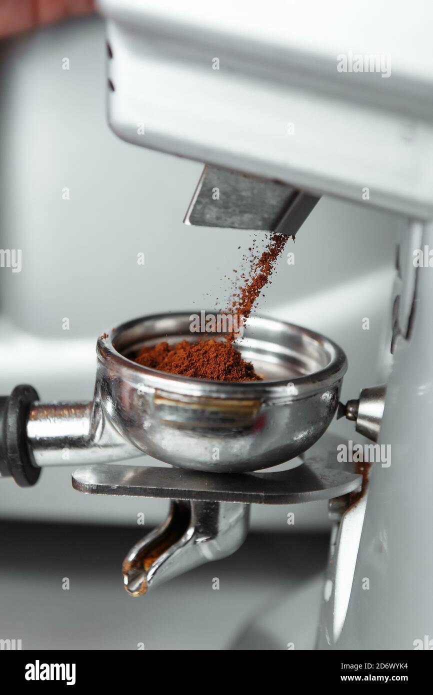 coffee grinder grinding freshly roasted make beans into a powder Stock ...