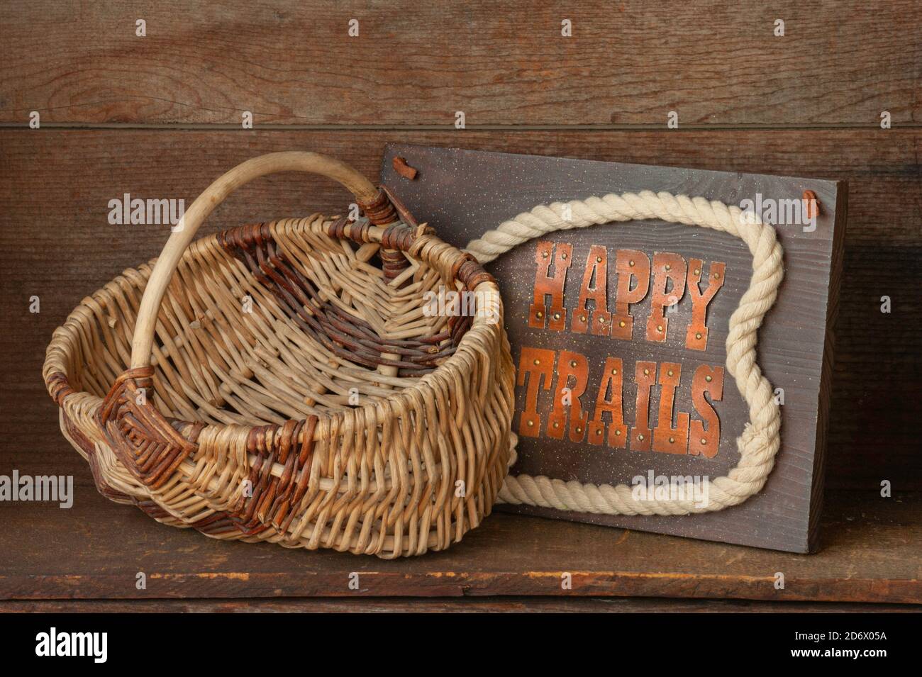 Happy Trails sign next to antique gathering basket Stock Photo - Alamy