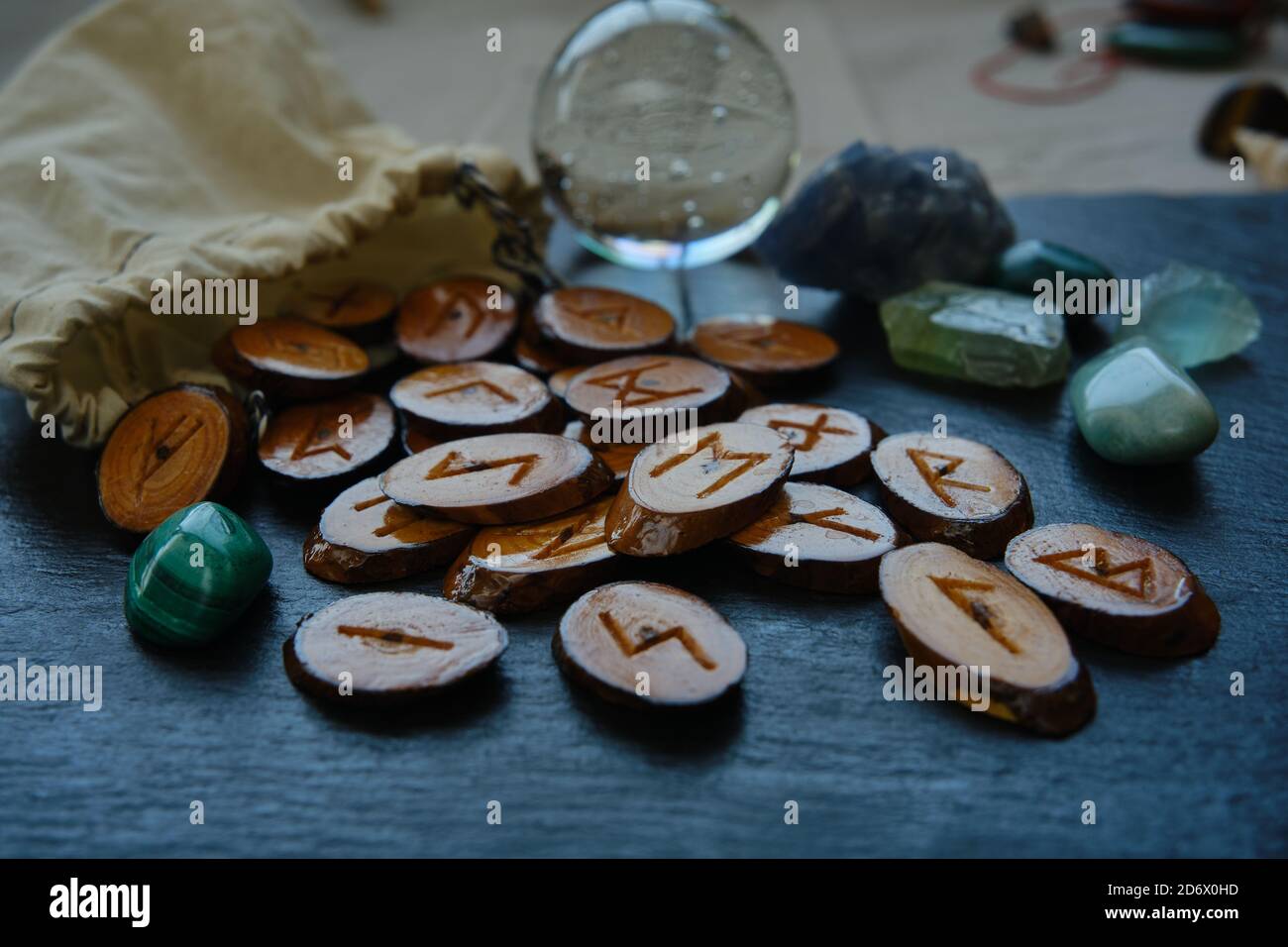 handmade wooden runes scattered on a black stone background Stock Photo ...