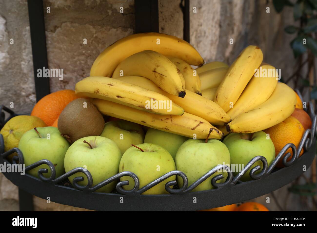 Decorative metallic tray filled with bananas, apples, kiwis and other ...