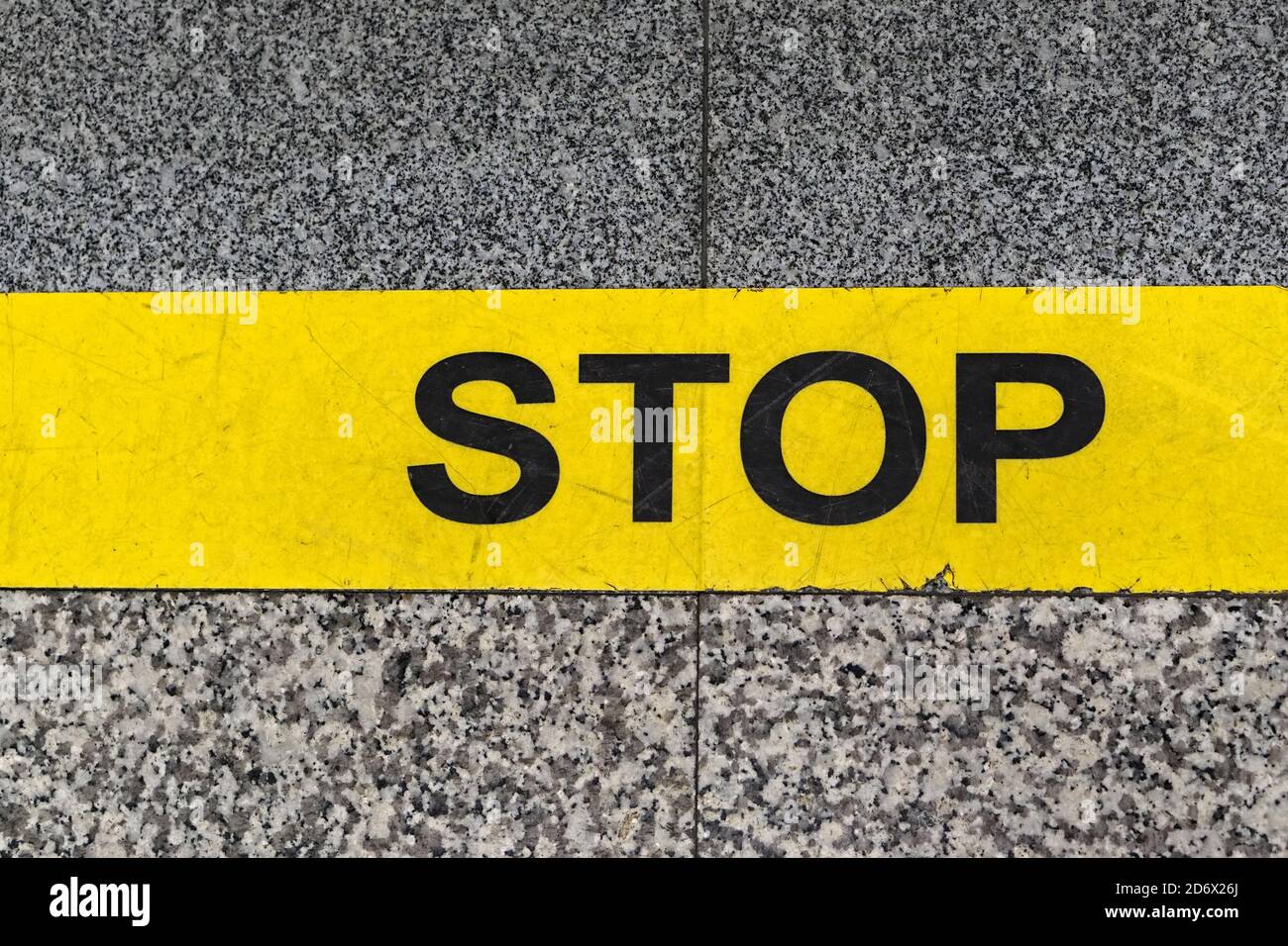 Stop sign yellow line at marble floor caution Stock Photo - Alamy
