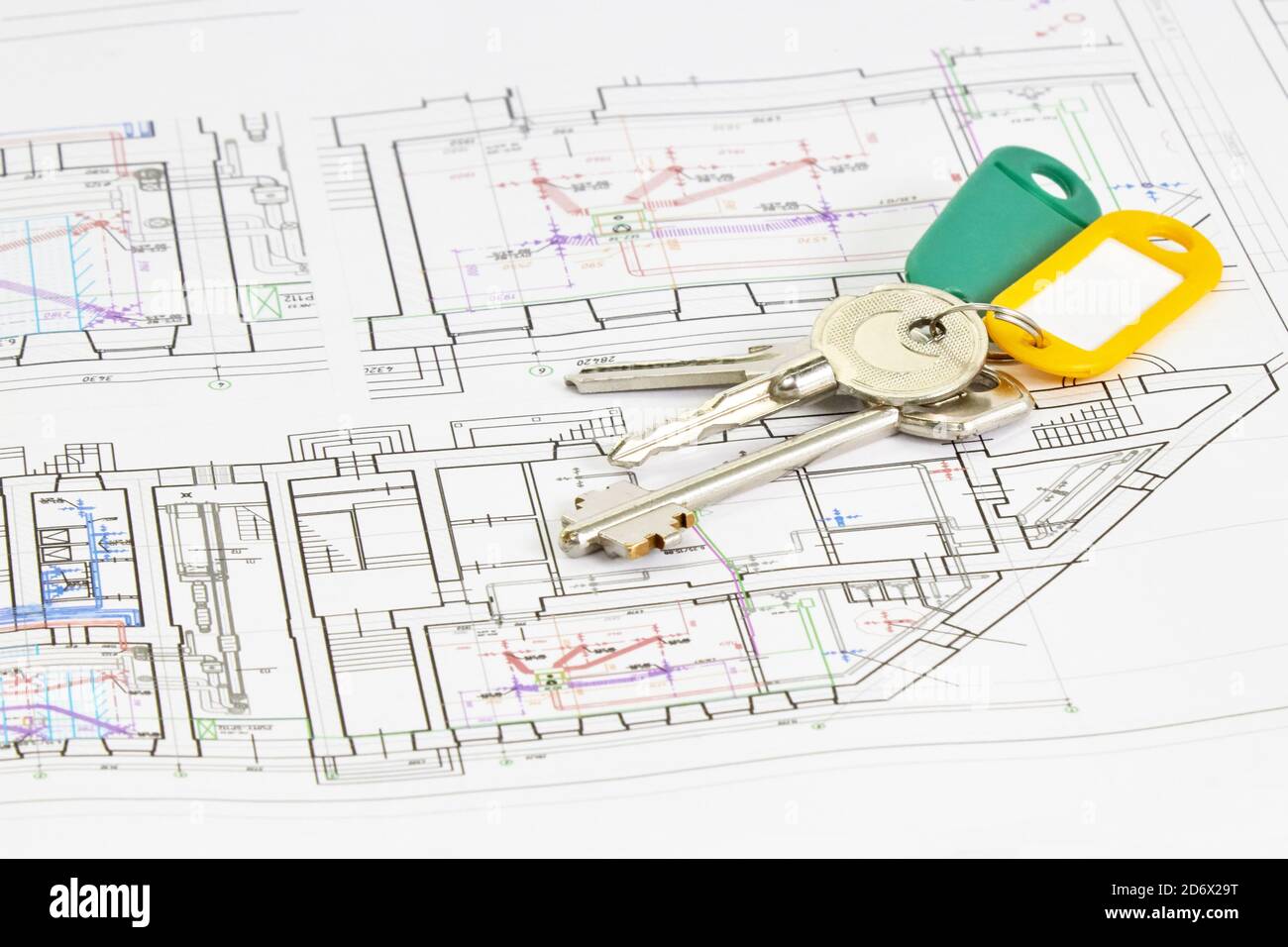 architectural drawings on a white sheet with keys to the house, the ...