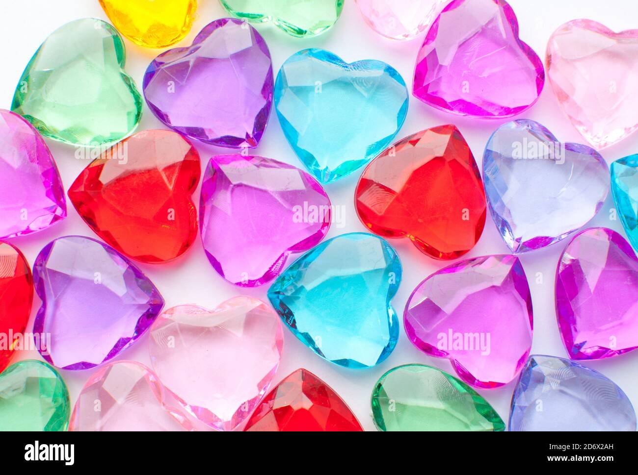 Multicolored hearts crystals on white background Stock Photo - Alamy