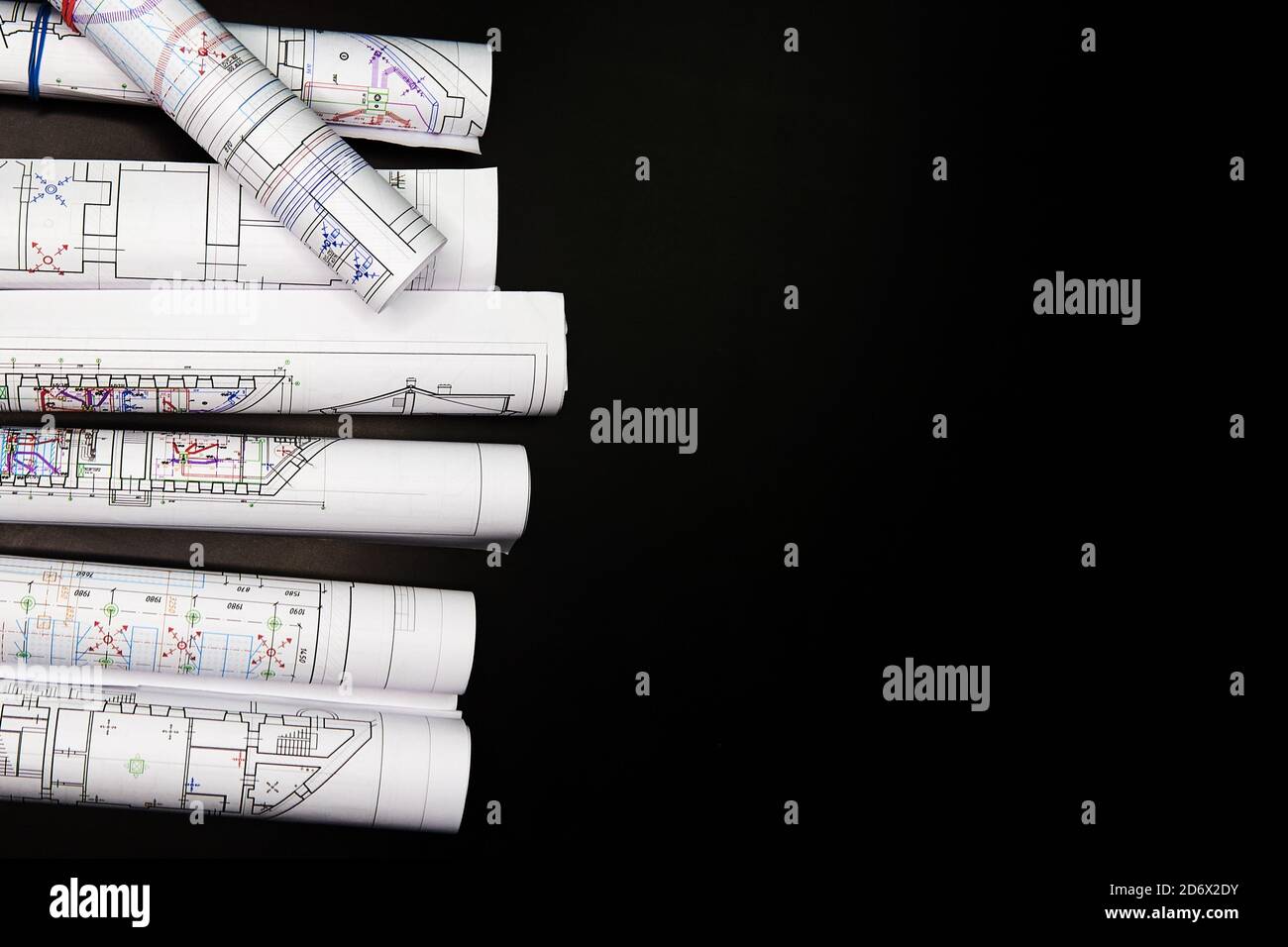 Architectural project, drawings on a dark background. Rolls of project ...