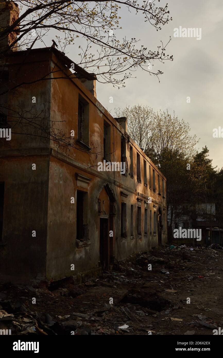 scary abandoned building with dark Windows at sunset Stock Photo - Alamy