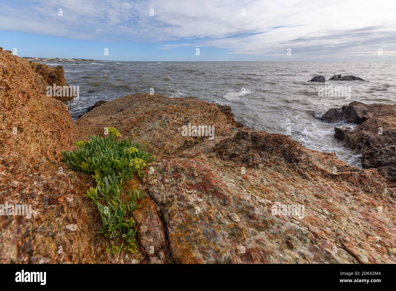 Breaking waves on the rocks of a cliff on the French Atlantic coast in ...