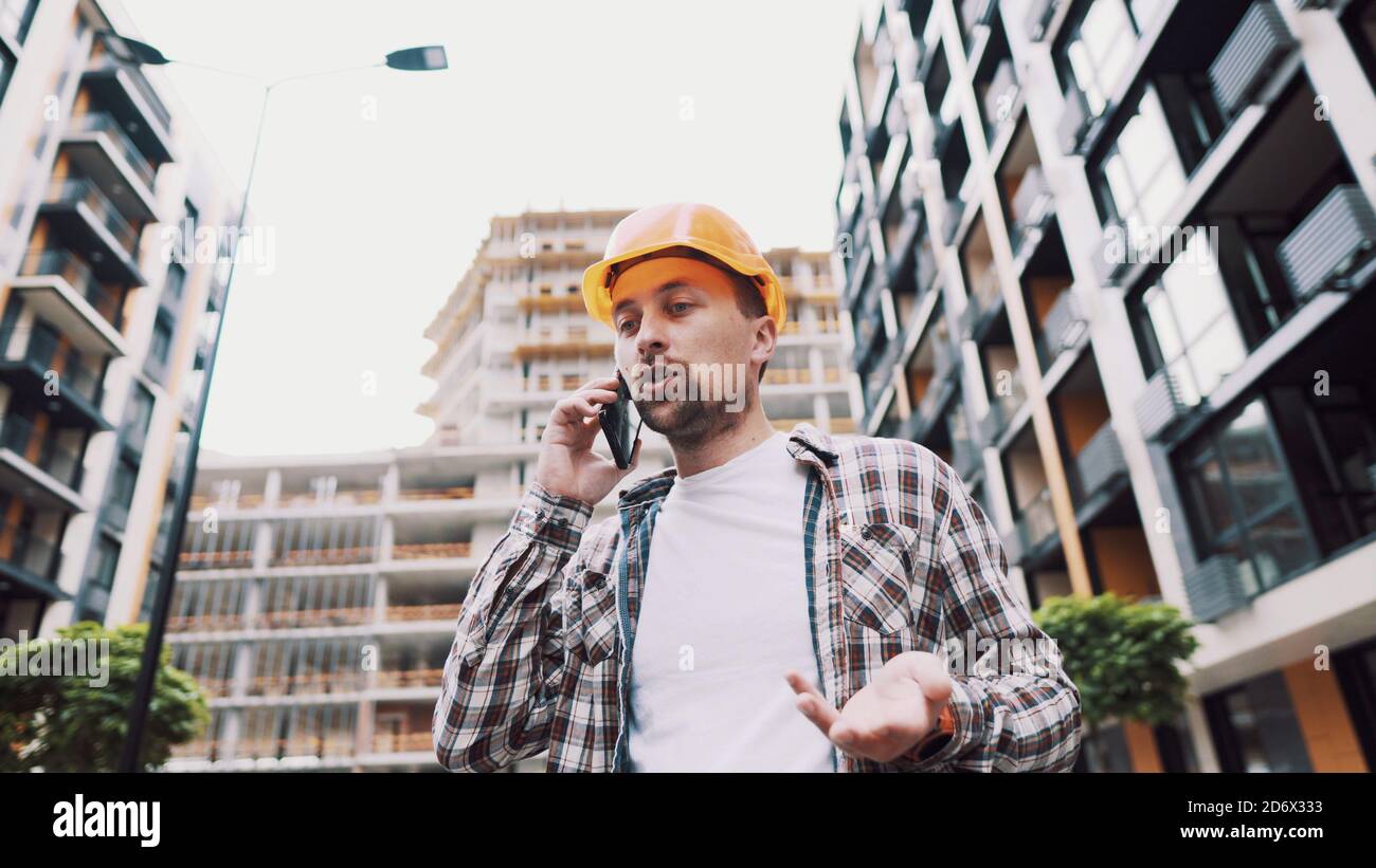 Angry builder, dissatisfied with deadline of work, swears at stress ...