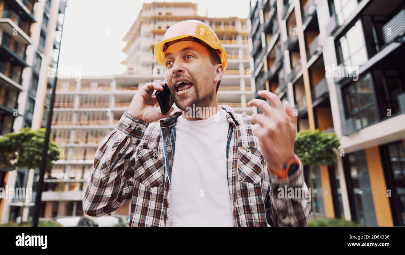 Angry builder, dissatisfied with deadline of work, swears at stress ...