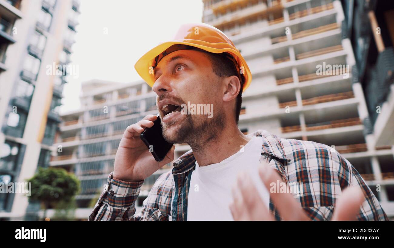 Angry builder, dissatisfied with deadline of work, swears at stress ...