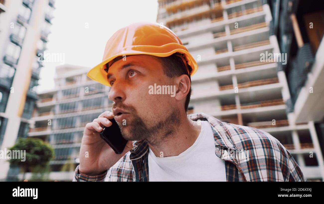 Angry builder, dissatisfied with deadline of work, swears at stress ...