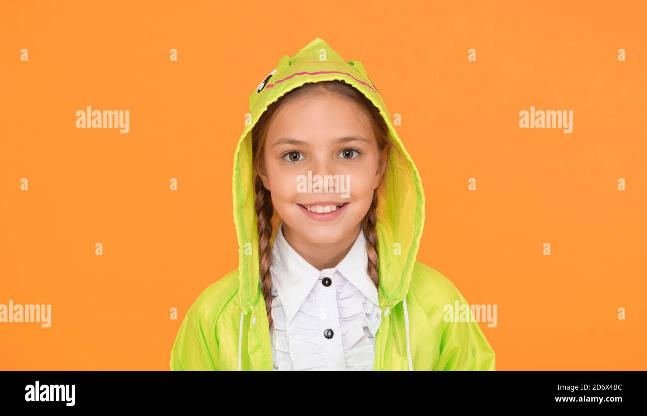 Bright smile whatever the weather. Little girl with cute smile in hood ...