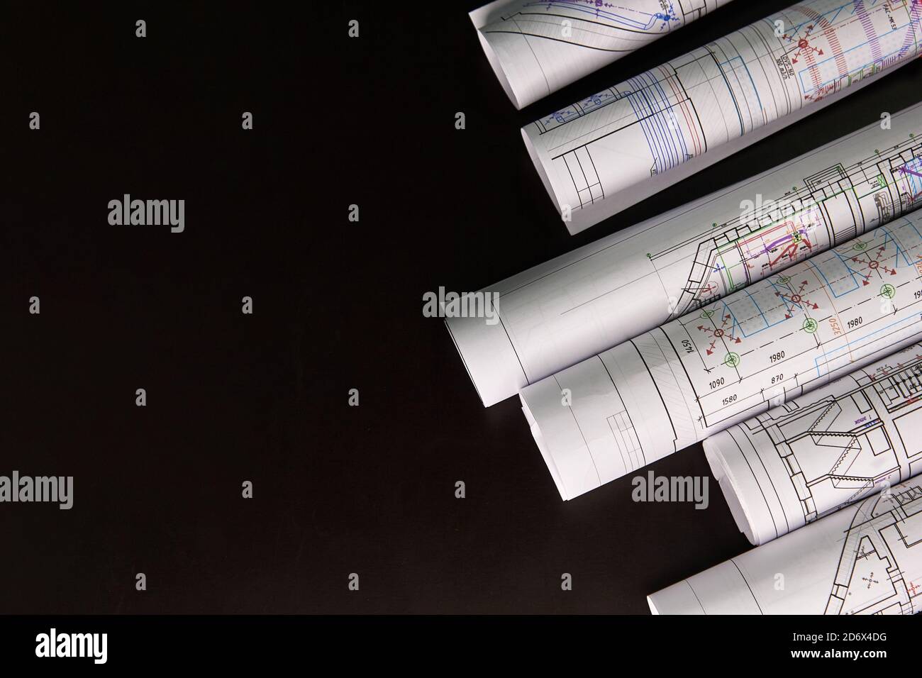 Architectural project, drawings on a dark background. Rolls of project ...