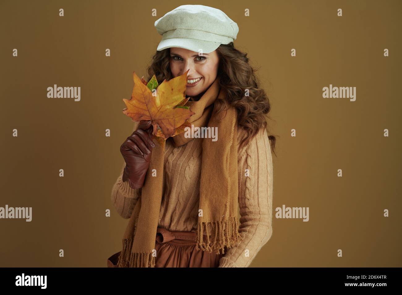 Hello november. Portrait of happy stylish woman in scarf with leather ...