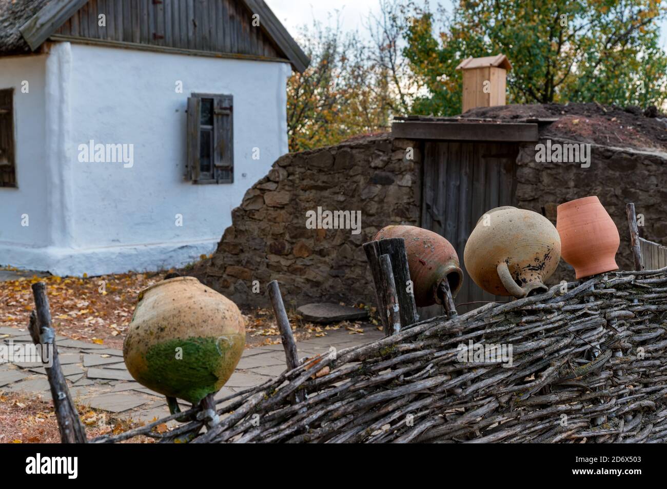 Clay jugs on a wooden fence of traditional houses and cossack family ...