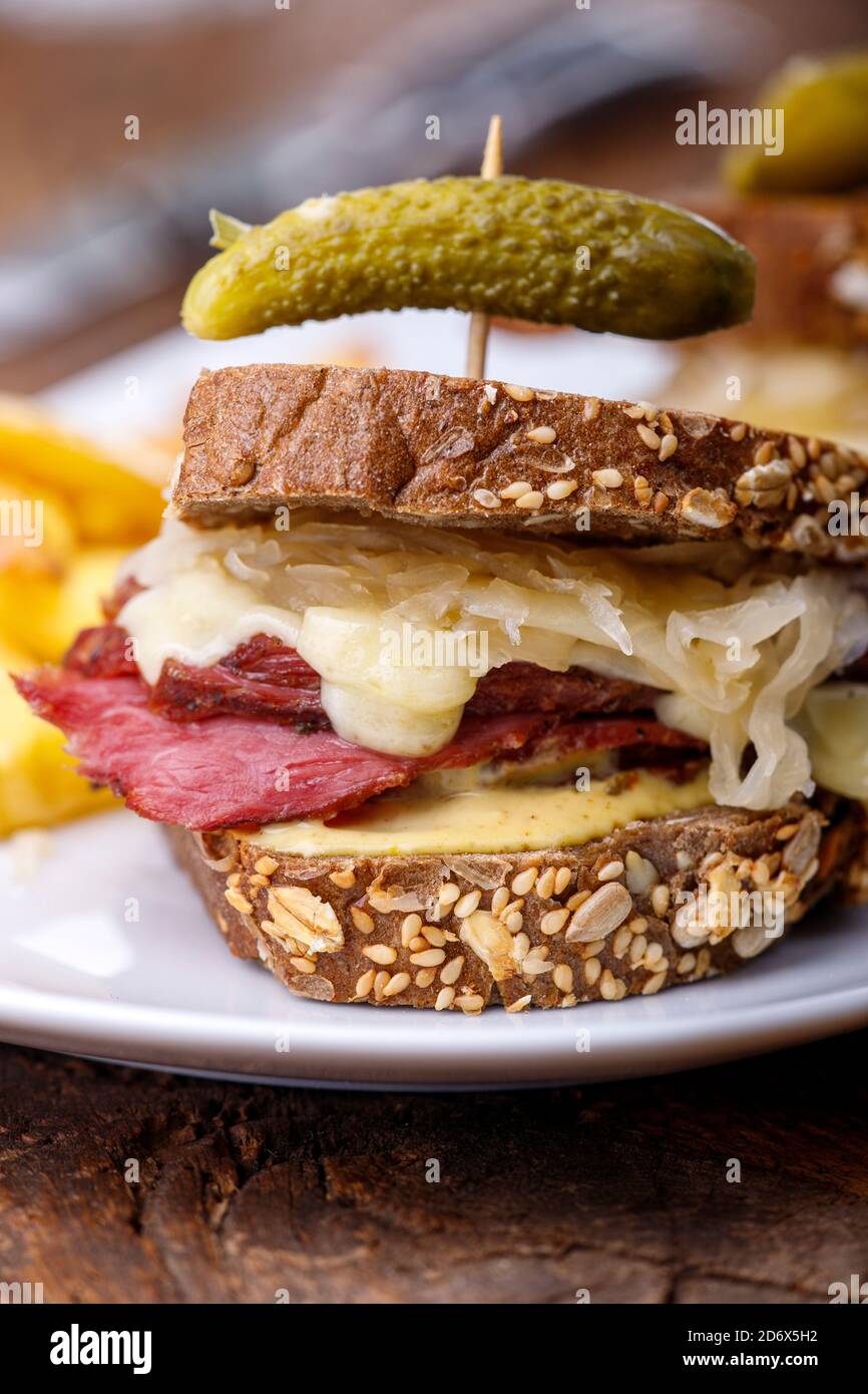 reuben sandwich on rustic wood Stock Photo - Alamy