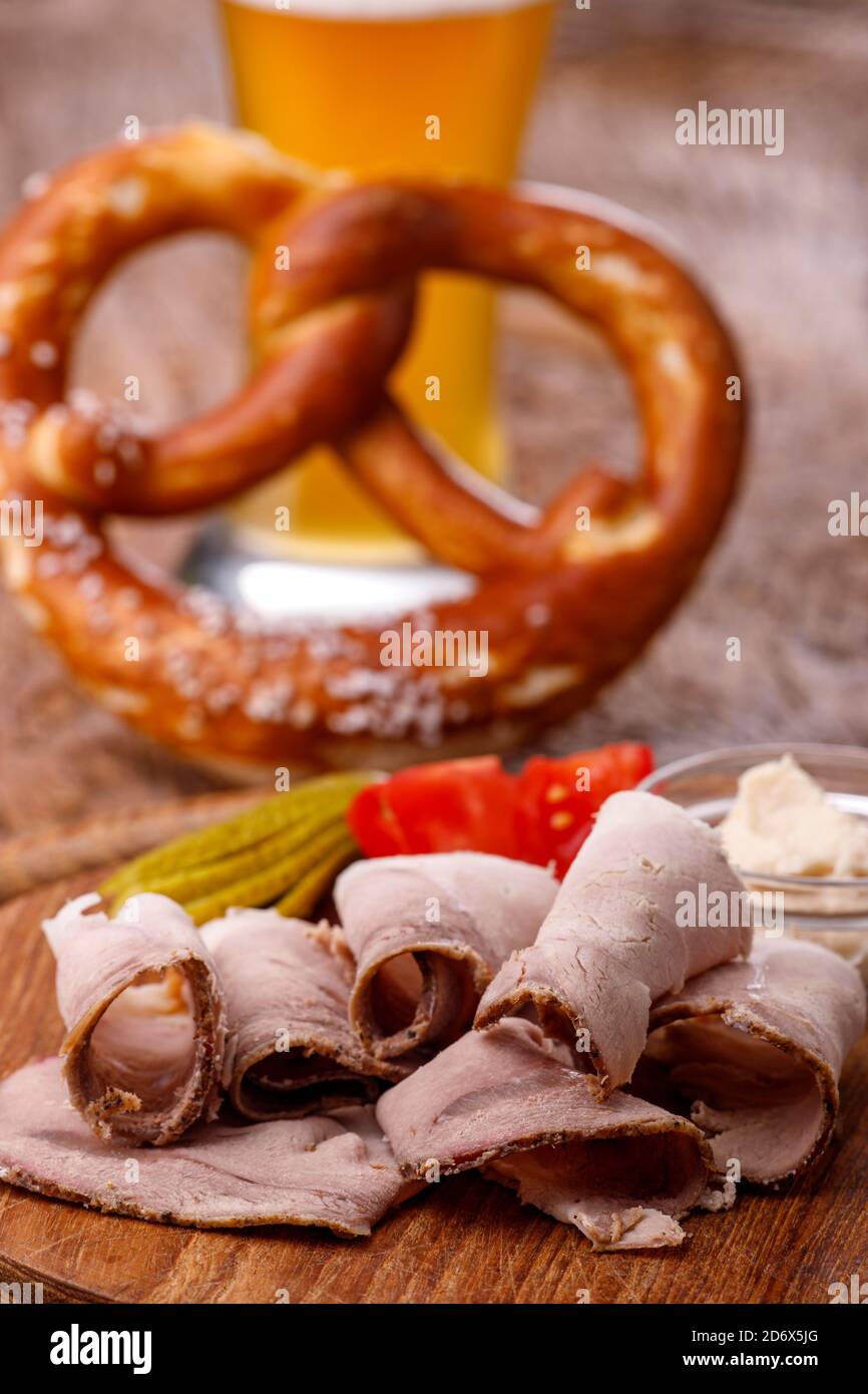 bavarian sliced cold pork on wood Stock Photo - Alamy