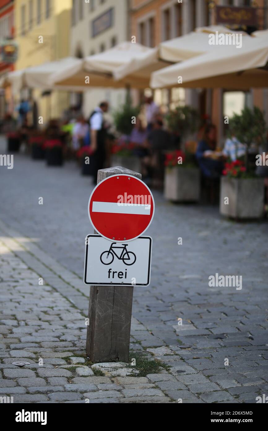 Vertical selective focus shot of a stop sign with a bicycle sign below ...