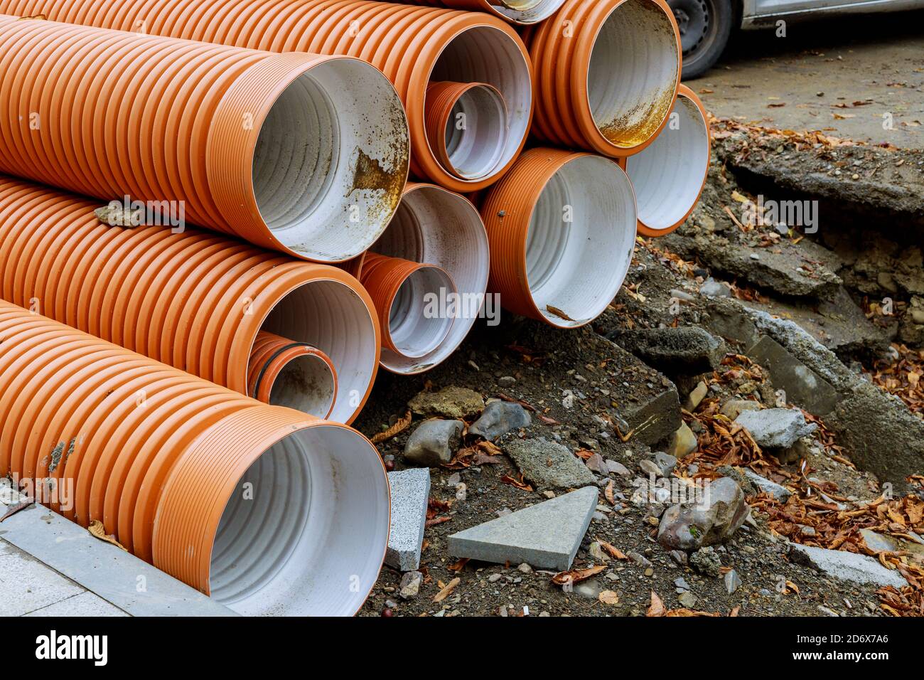 PVC tubes plastic pipes stacked in rows at a construction site on ...