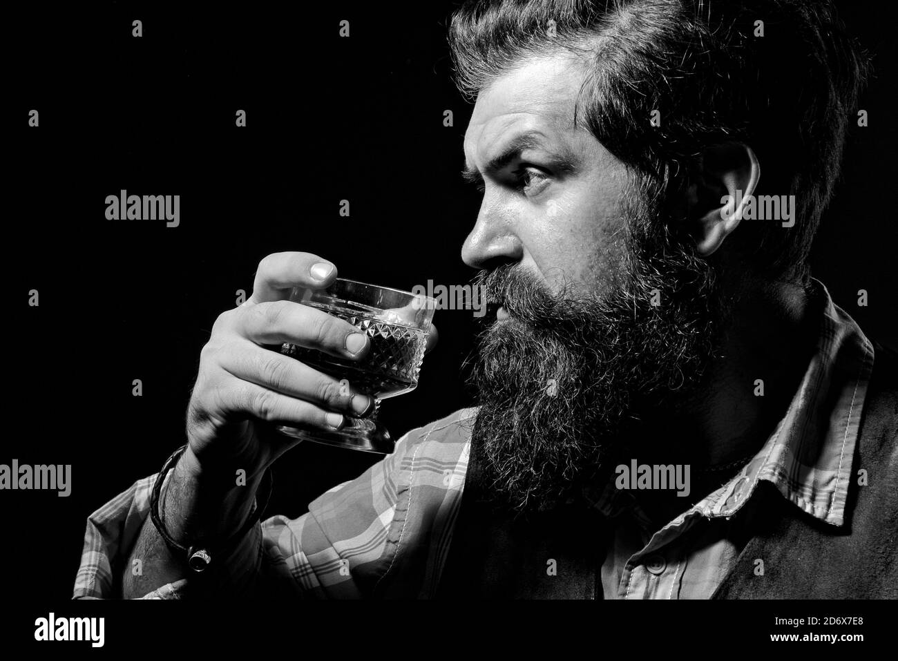 An elegant man suffering from alcoholism drinking whisky. Bearded ...