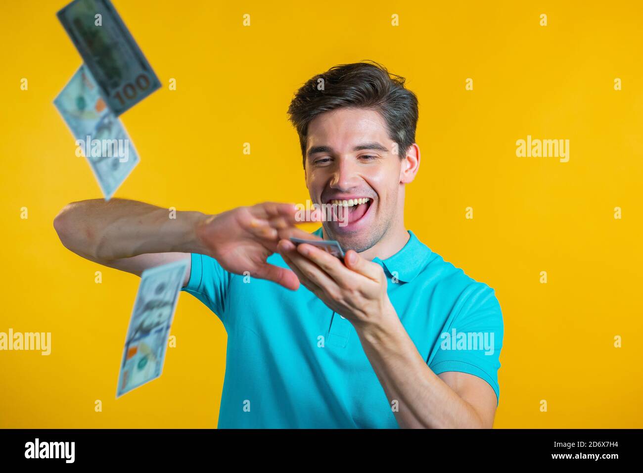 Man with a happy face scatters money. People overspend US currency. The ...