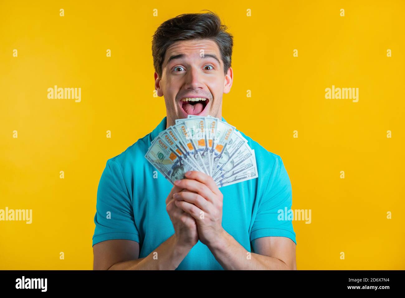 Amazed happy excited man with money - U.S. currency dollars banknotes ...
