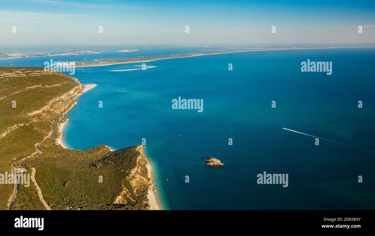 Aerial view of blue Atlantic ocean, green forest mountains and sandy ...