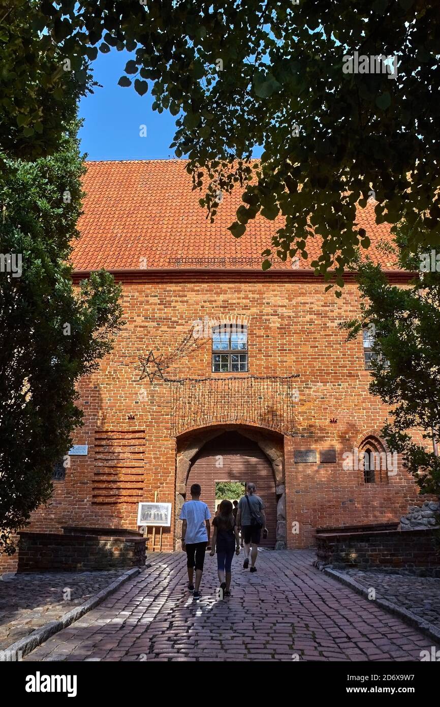 Ostroda, Poland - July 4, 2020. Rear view of tourists walking towards ...