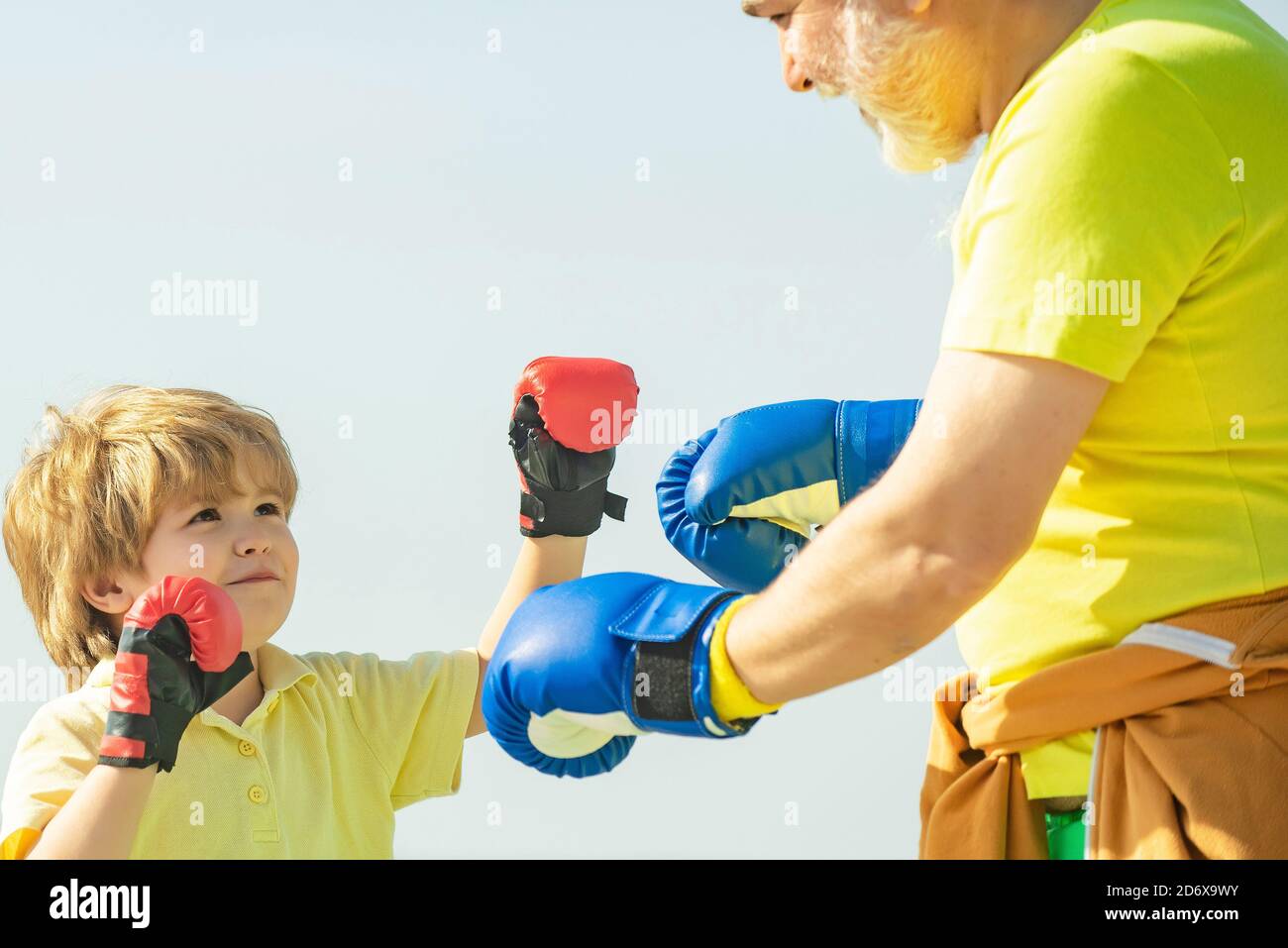 Handsome elderly man practicing boxing kicks. Elderly man hitting ...