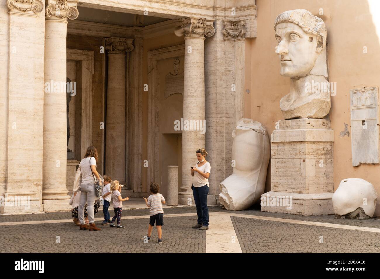 Tourists inside the The Capitoline Museums next to parts of the ...
