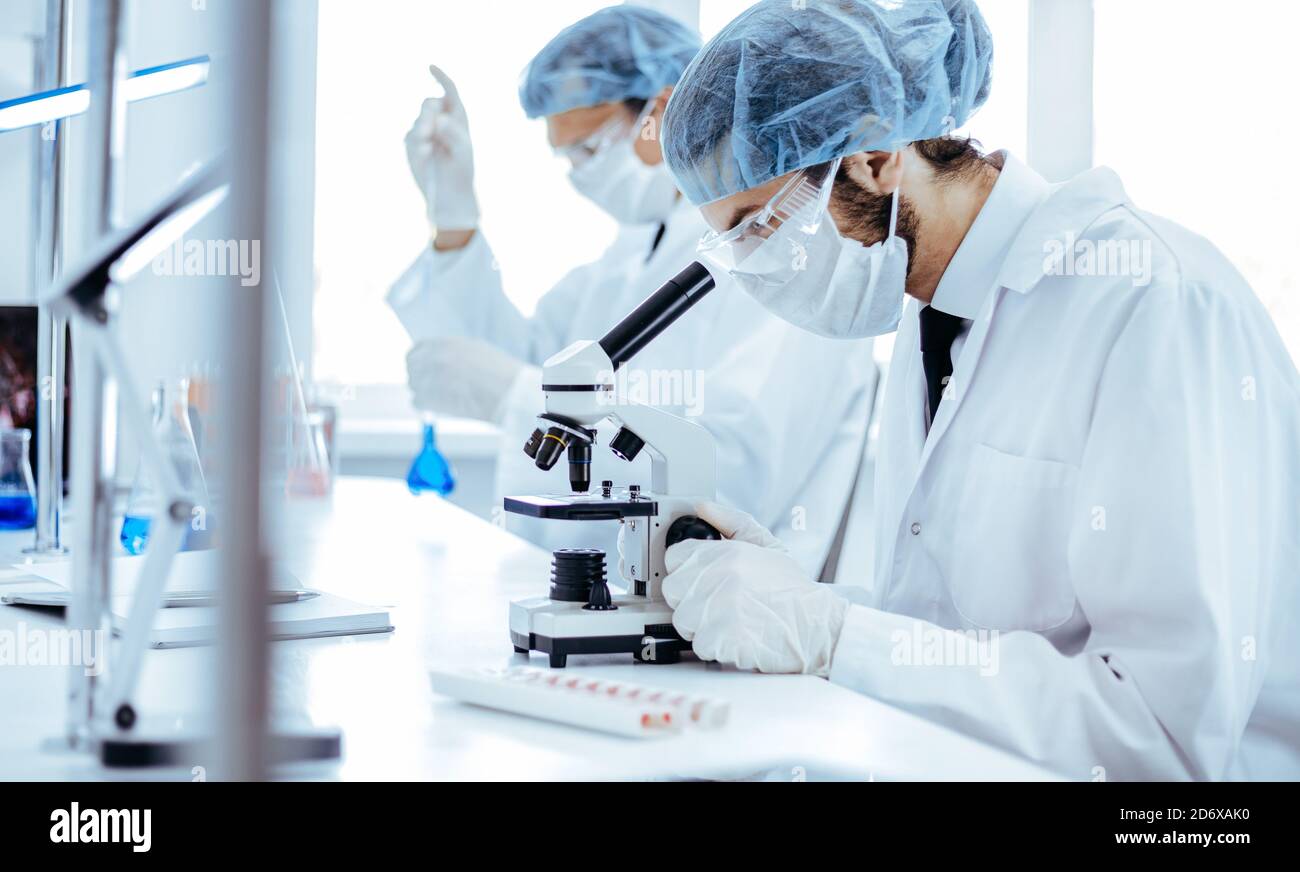 Man scientist vial microscope hi-res stock photography and images - Alamy