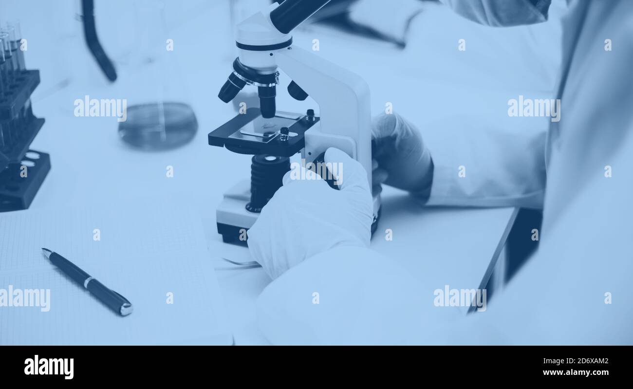 close up. image of a scientist looking through a microscope Stock Photo ...