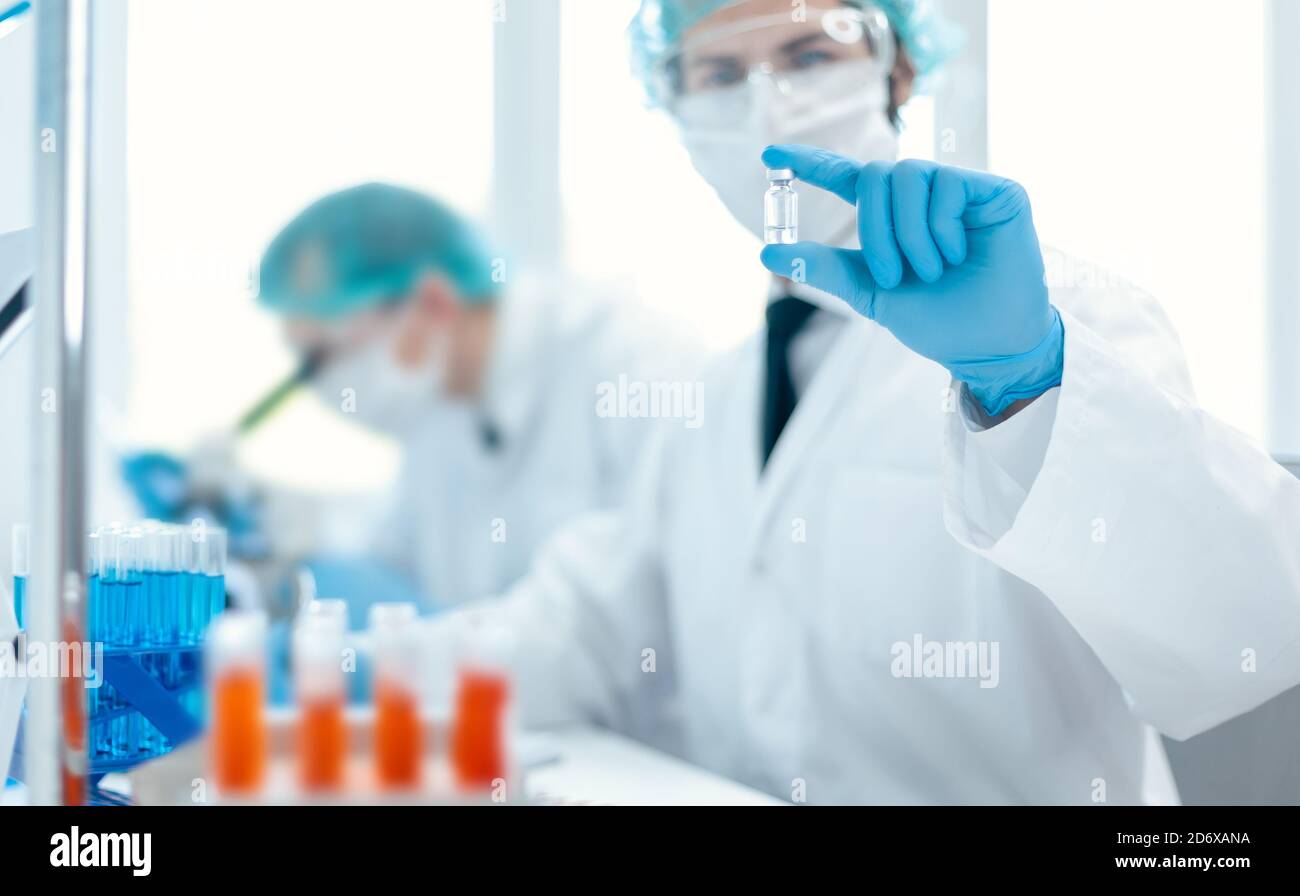 background image of a scientist recording test results in a lab log ...
