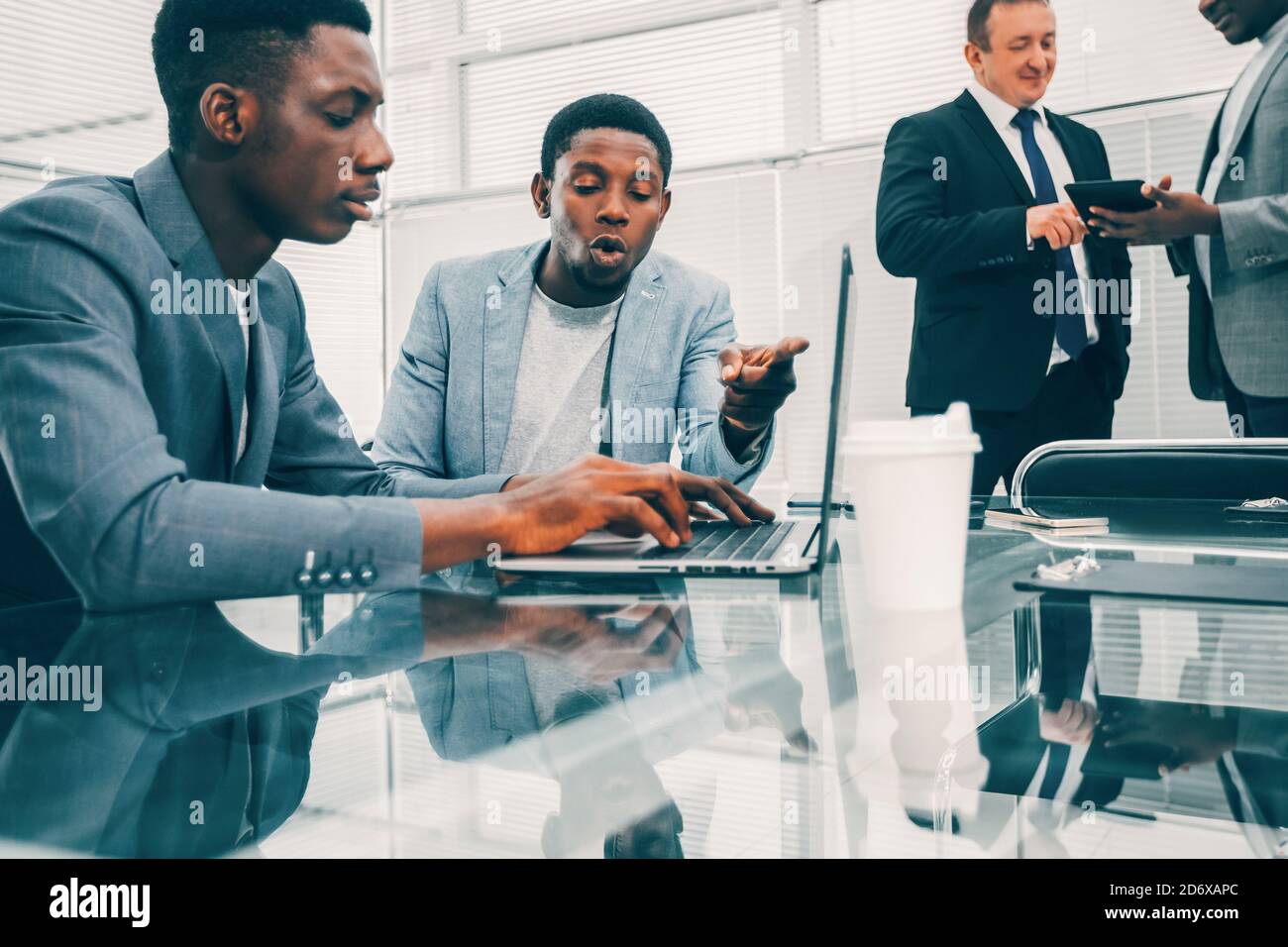 young employees using a laptop in the office Stock Photo - Alamy
