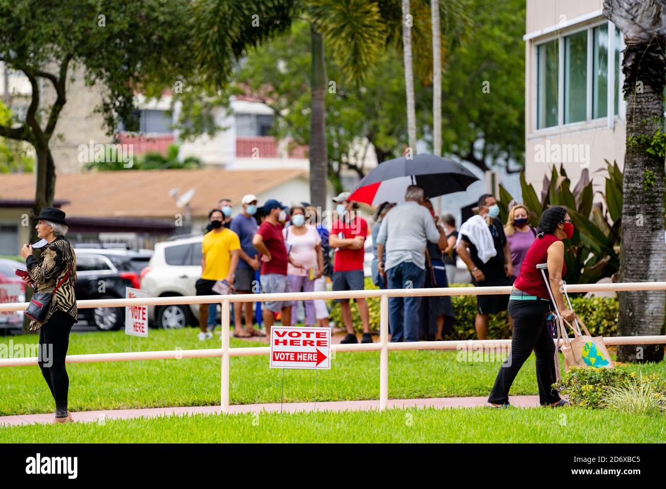 Voting line starts here photo people waiting Stock Photo - Alamy
