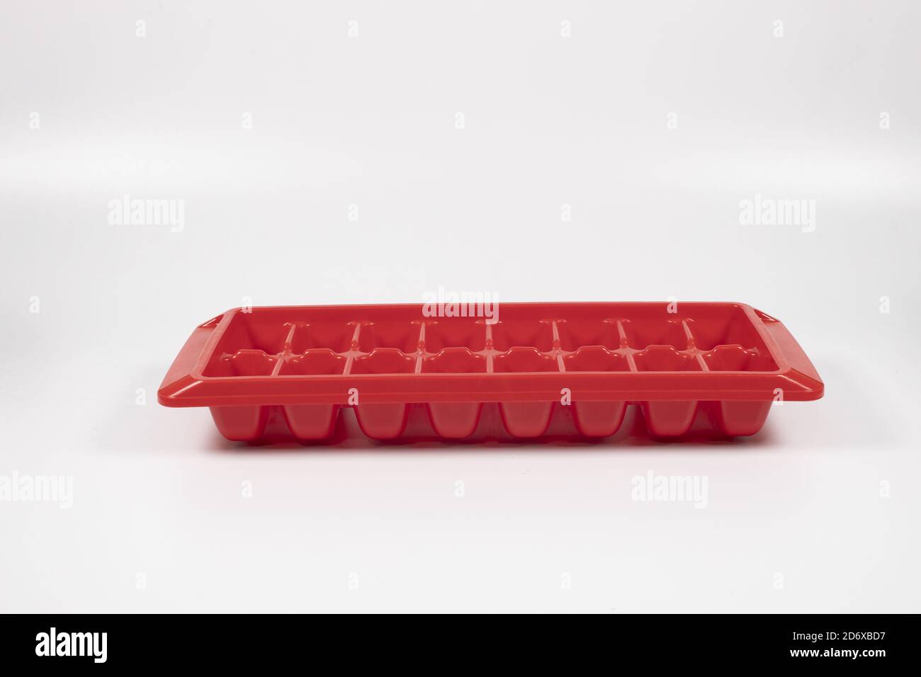 Closeup shot of a red ice cube tray on white background Stock Photo - Alamy