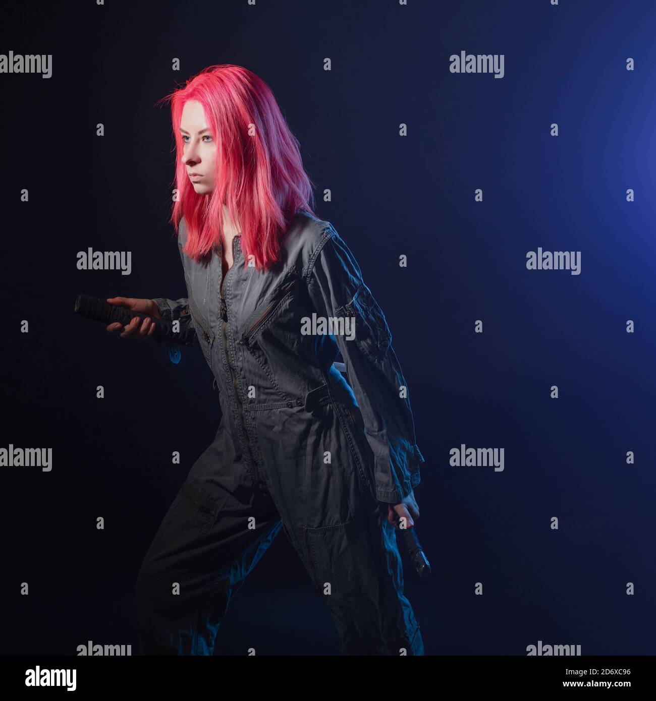 Cyberpunk and futurism, concept. A young woman with pink hair and ...