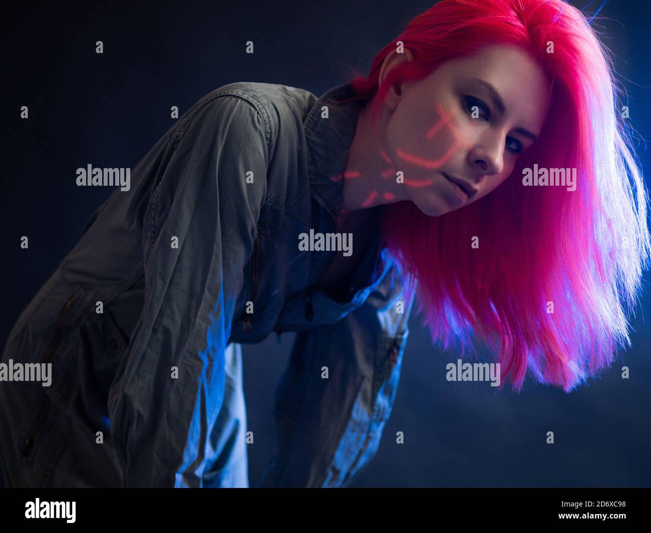 Cyberpunk and futurism, concept. A young woman with pink hair and a ...