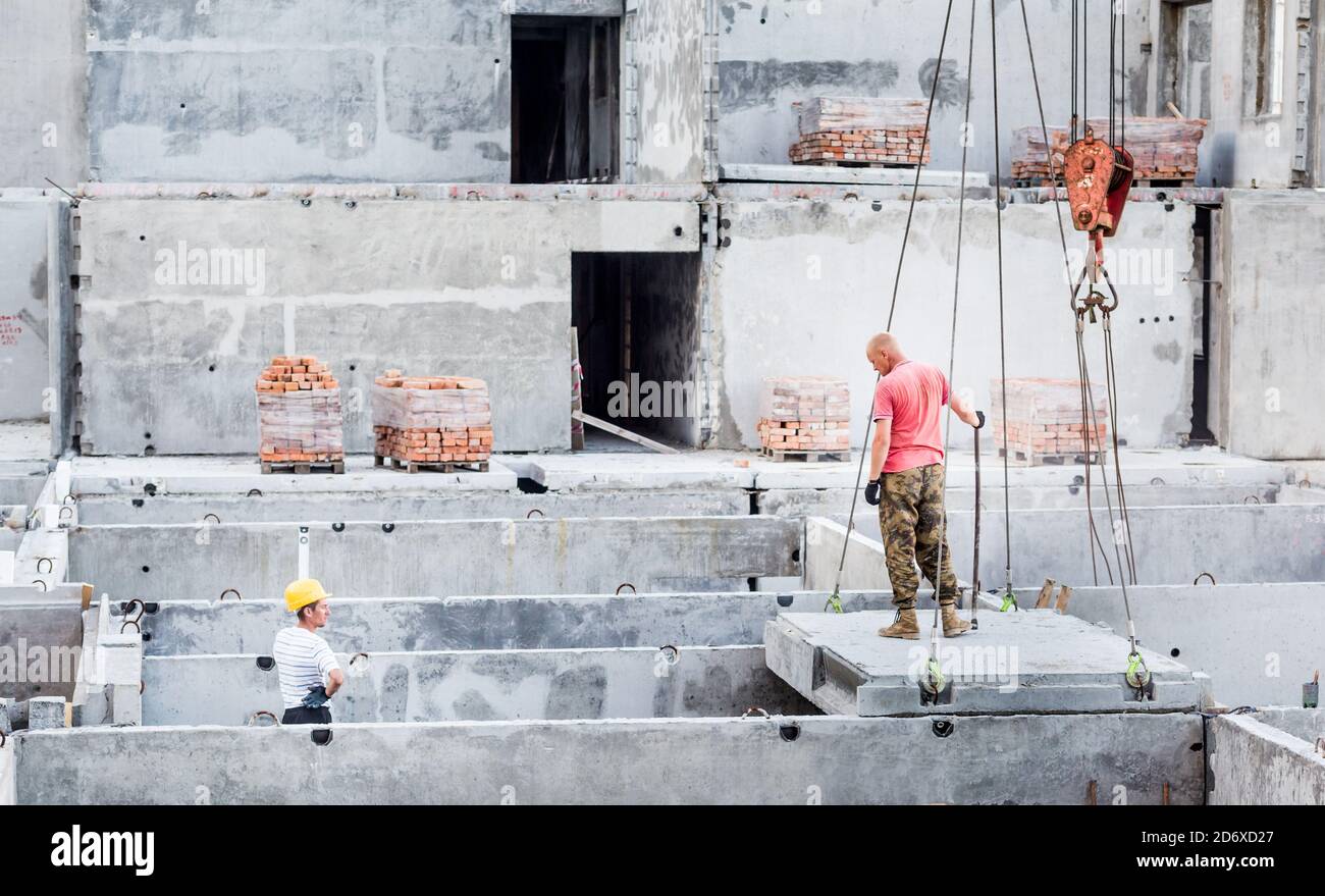 Russia, Vladivostok, 07/21/2020. Workers on the construction of high ...