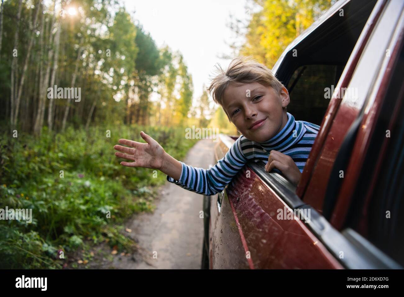 Cheerful child who is looking out of an open window of the car Stock ...