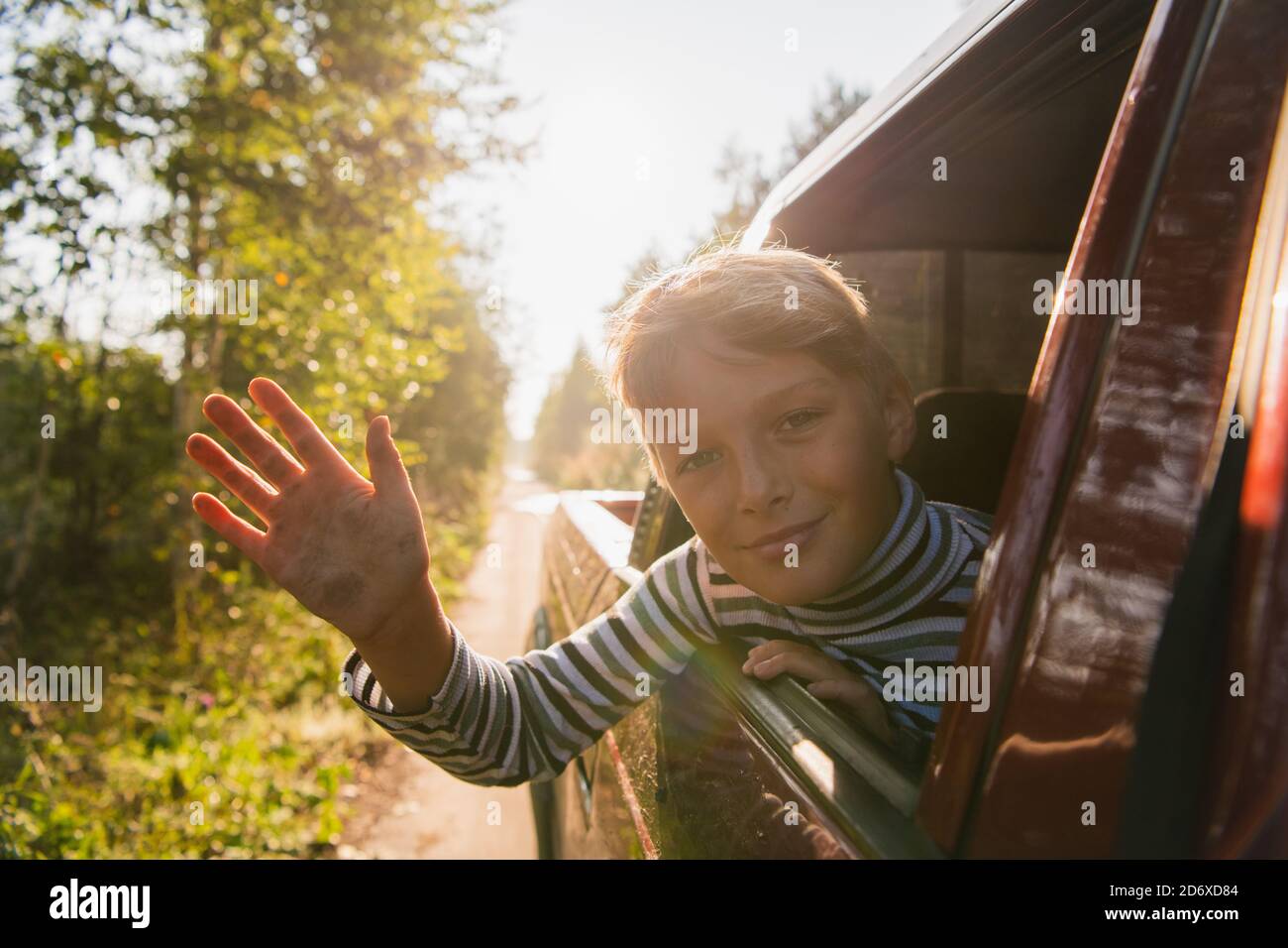 Cheerful child who is looking out of an open window of the car Stock ...