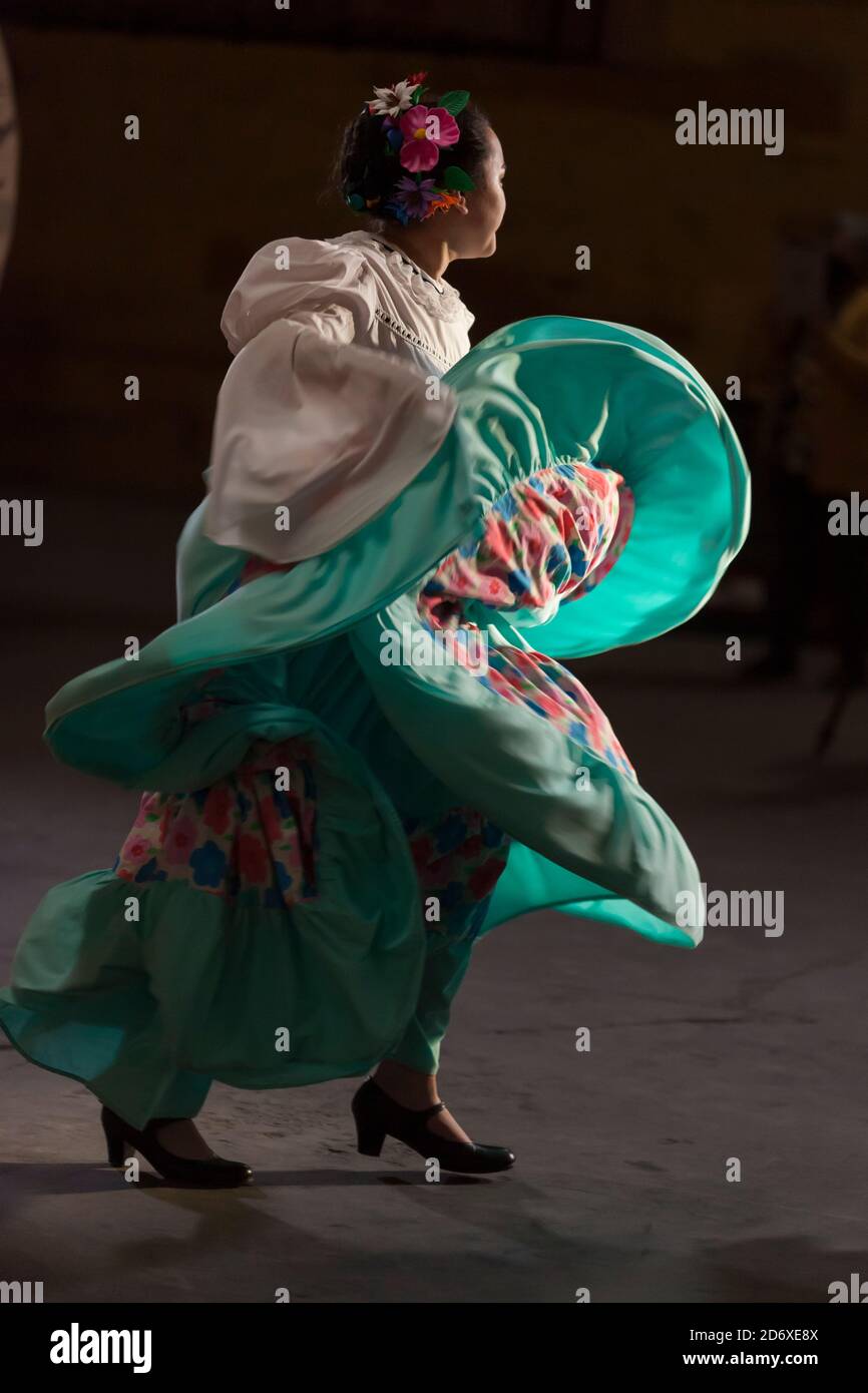 A member of el Grupo de Danza la Esperanza performs a dance typical to ...