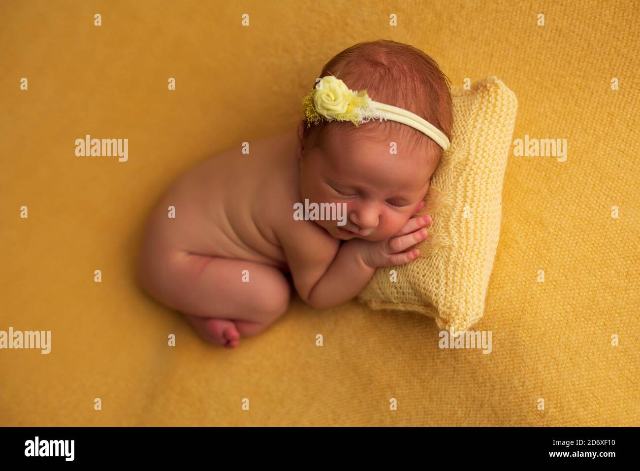 beautiful newborn sleeping baby on a yellow background Stock Photo - Alamy