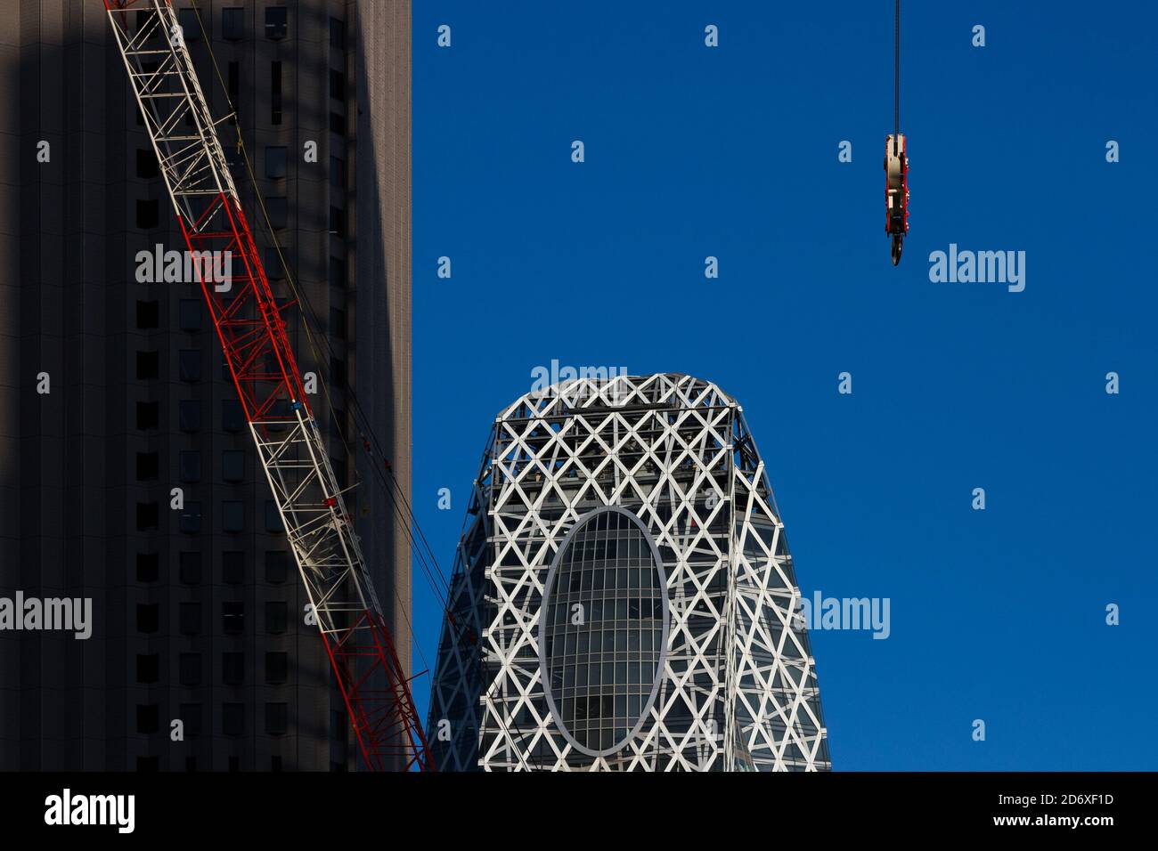 Cocoon Tower behind a construction site crane in Shinjuku, Tokyo, Japan ...